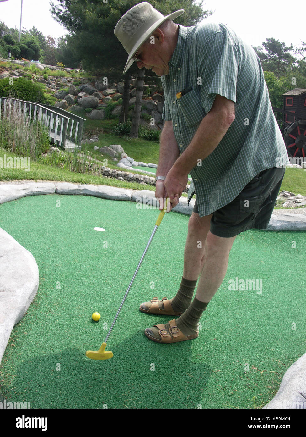 Man Playing Miniature Golf Stock Photo - Alamy