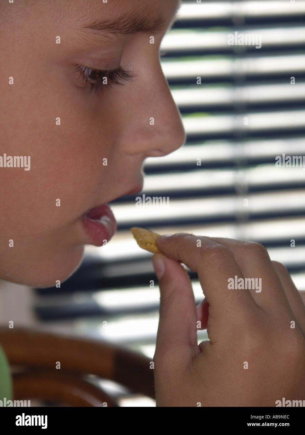 Young Boy Eating Cracker Stock Photo - Alamy