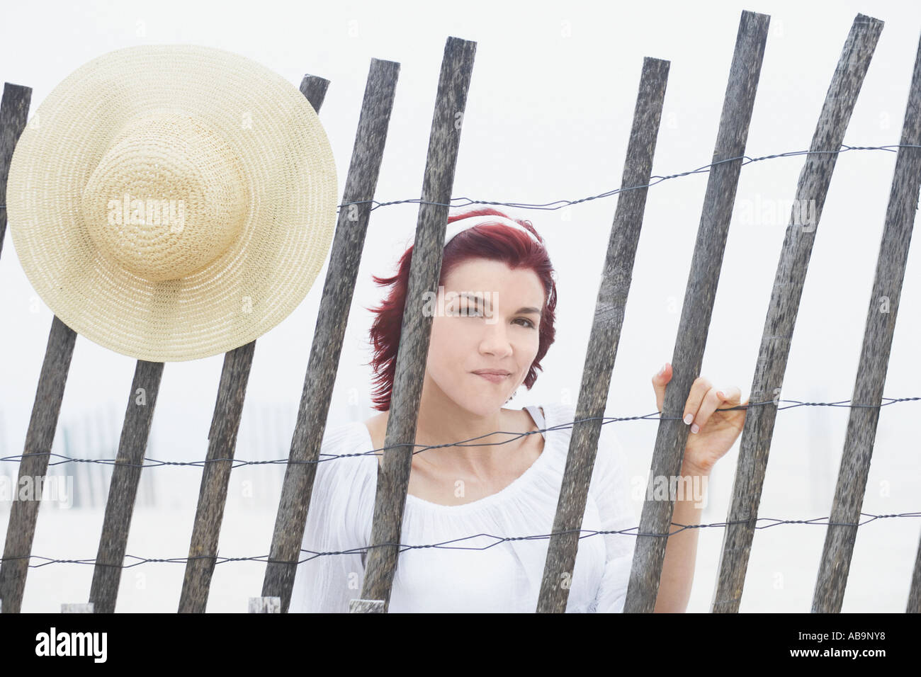 Woman behind fence hi-res stock photography and images - Alamy
