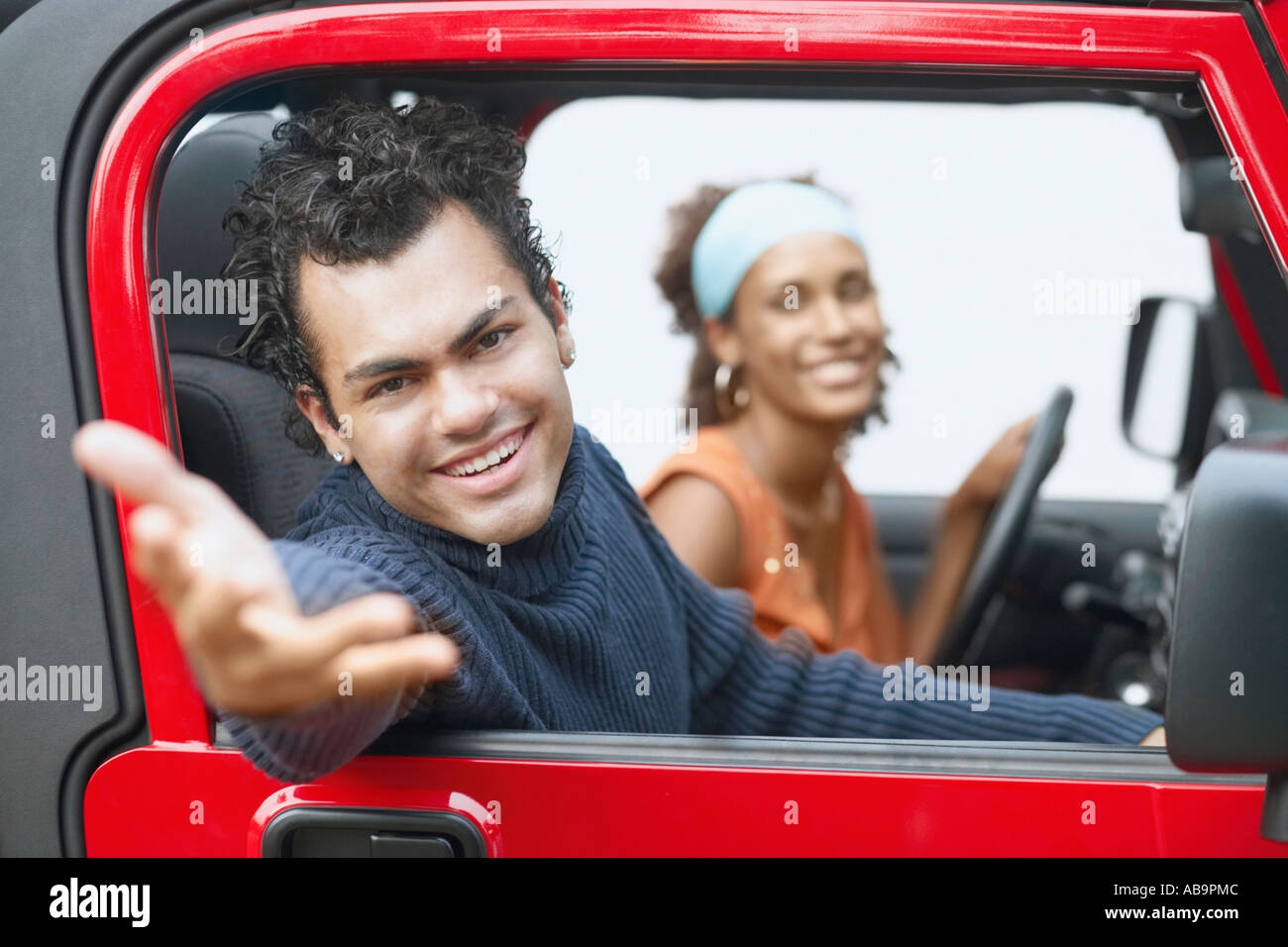 Young man reaching towards the camera for a Jeep Stock Photo - Alamy