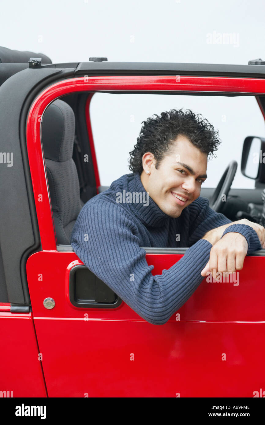 Young man riding in a Jeep Stock Photo - Alamy