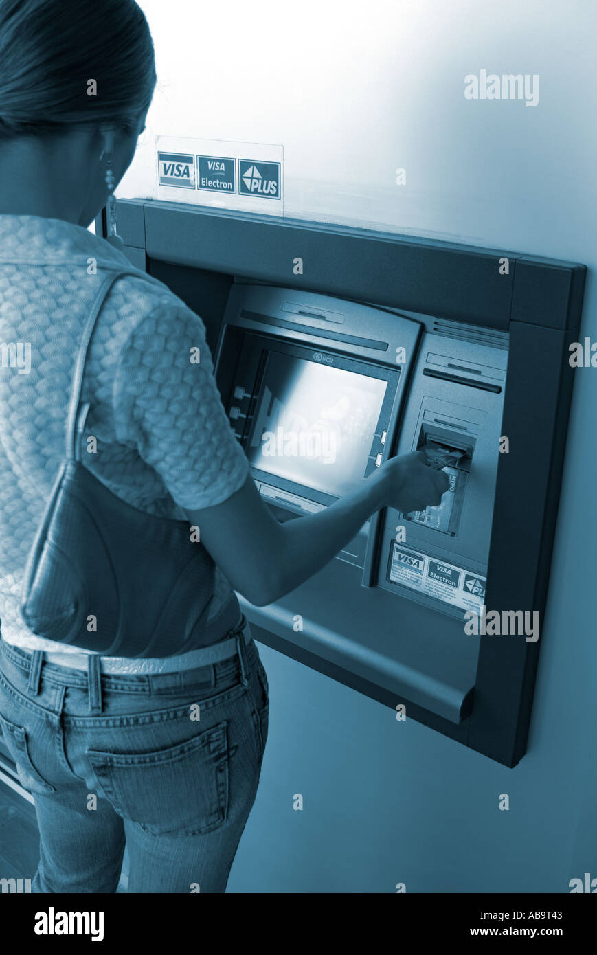 ATM Cashpoint Woman Inserting Her Card Stock Photo - Alamy