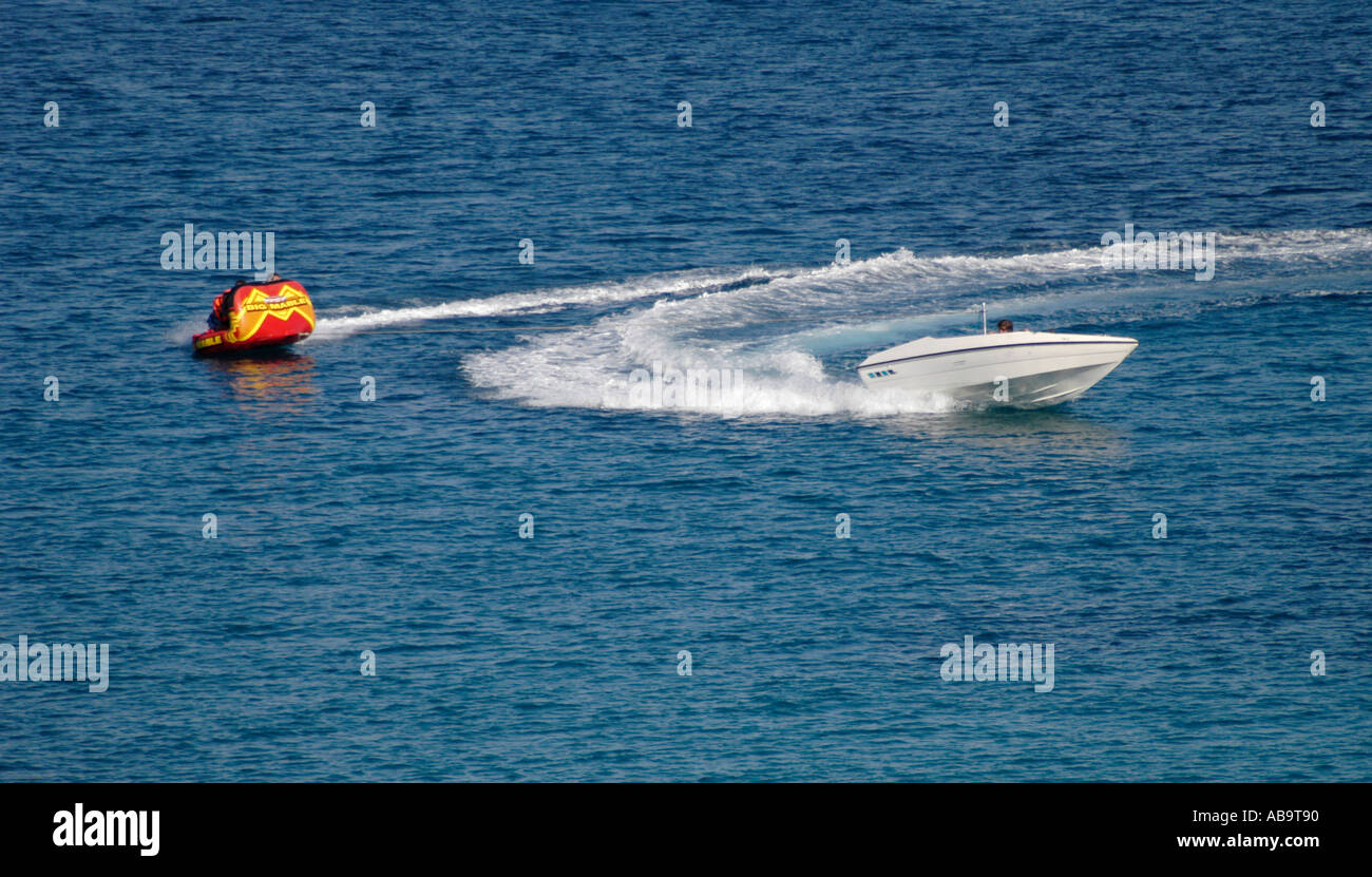 Speed boat pulling sea sport inflatable Stock Photo - Alamy