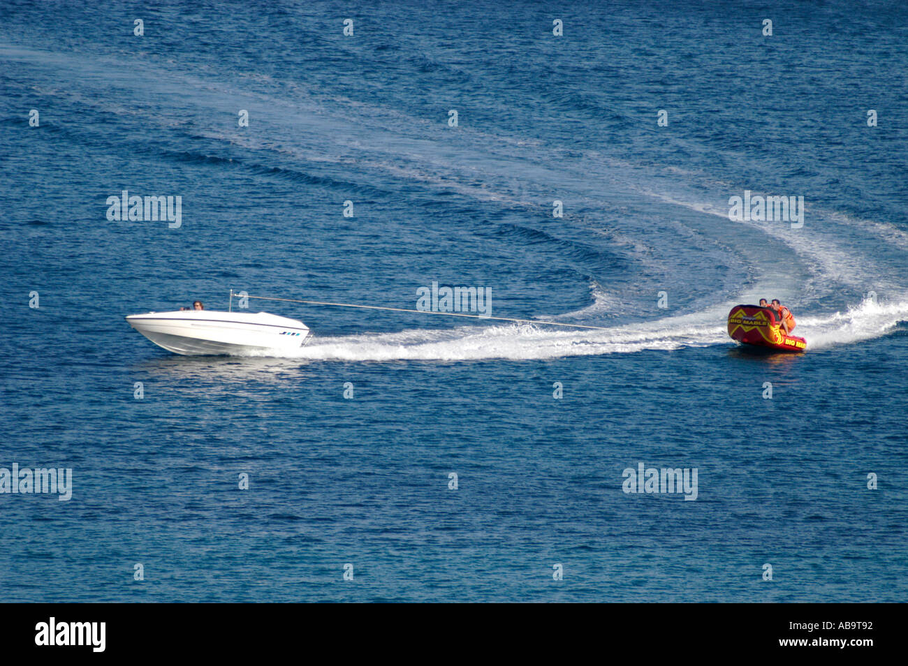 Speed boat pulling sea sport inflatable Stock Photo - Alamy