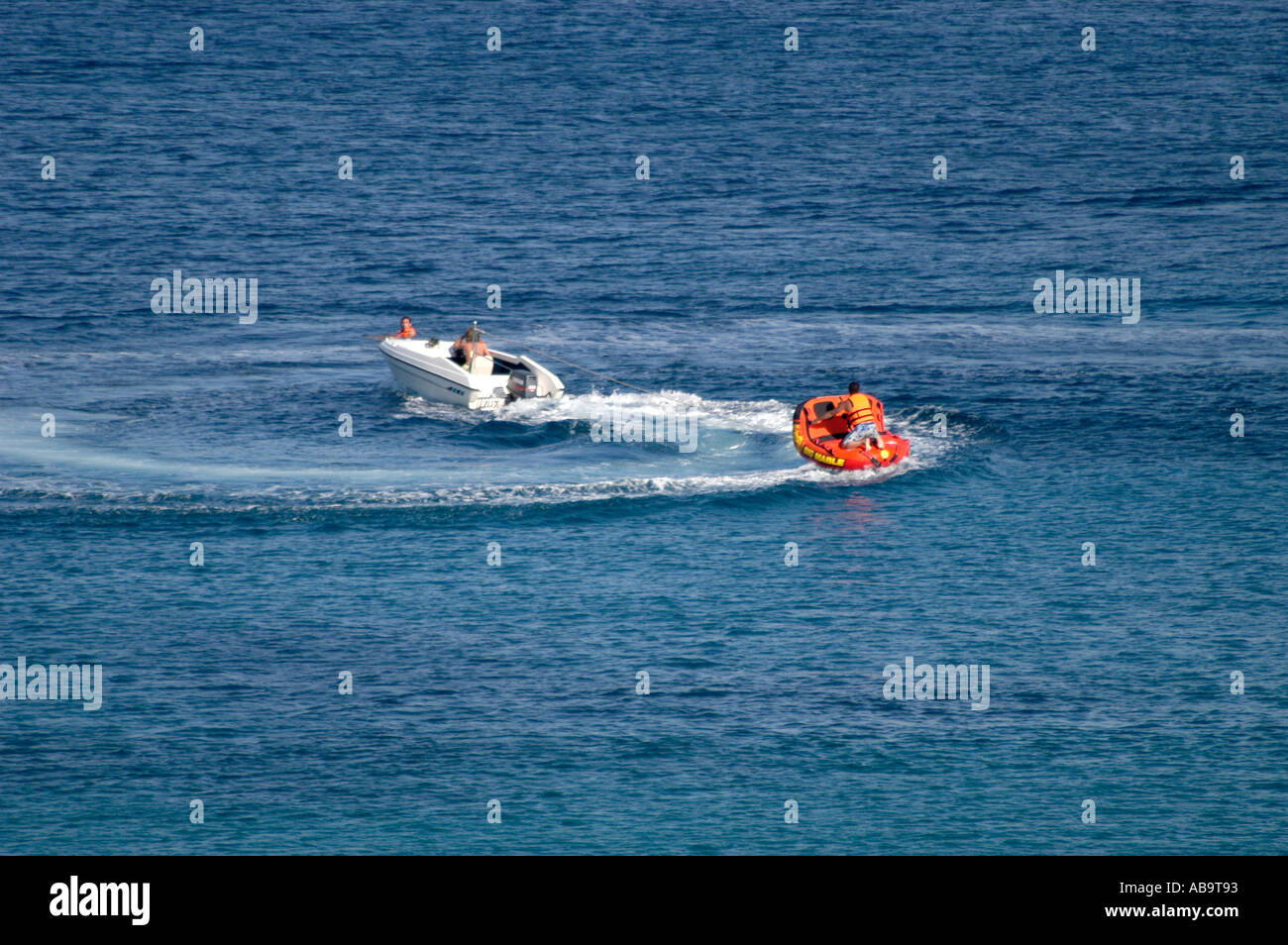 Speed boat pulling sea sport inflatable Stock Photo - Alamy