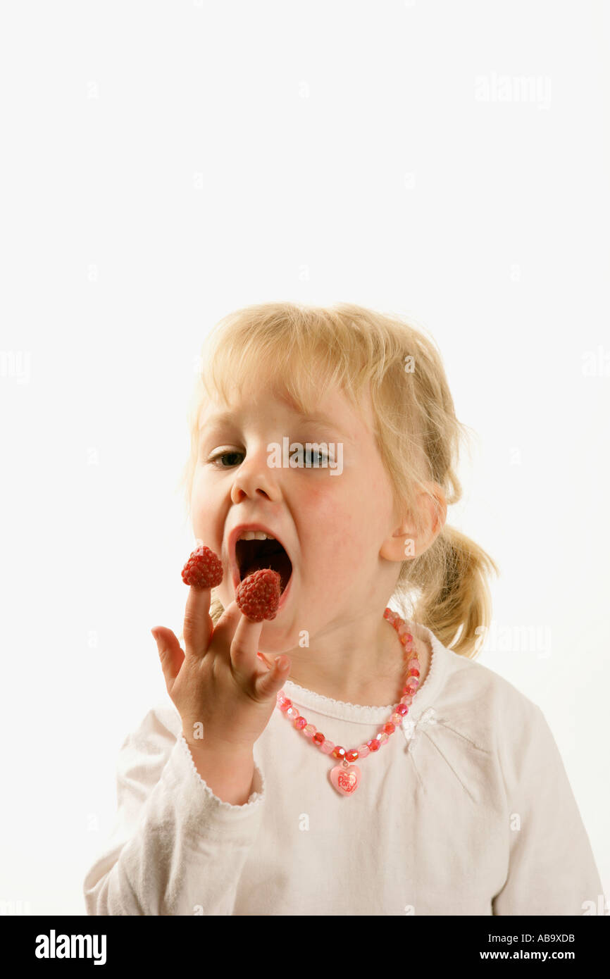 Toddler eating raspberries showing healthy eating for this age group ...