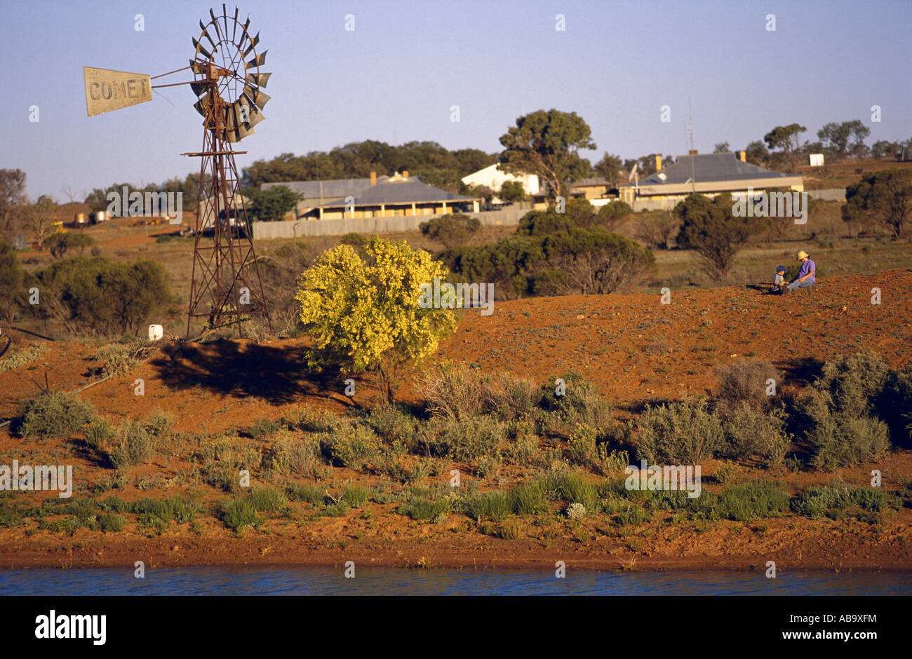 View across dam to outback homestead, near Broken Hill, New South Wales ...