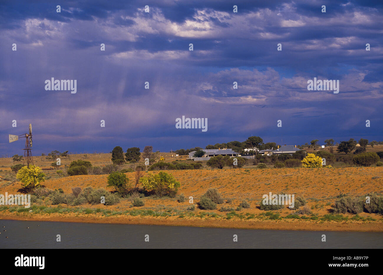View across dam to outback homestead, near Broken Hill, New South Wales ...