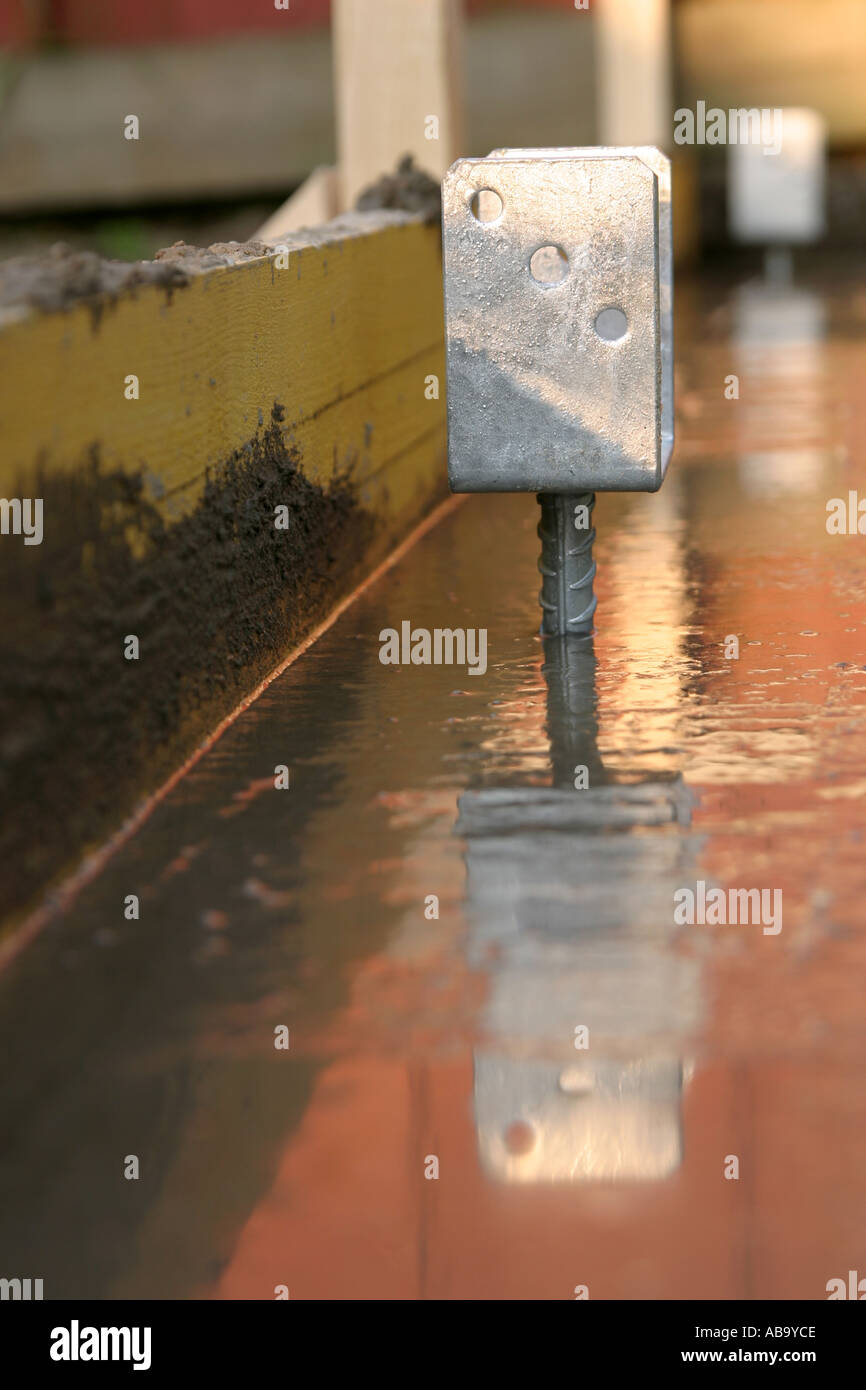 The holding bracket for a pole inserted in wet concrete Stock Photo - Alamy