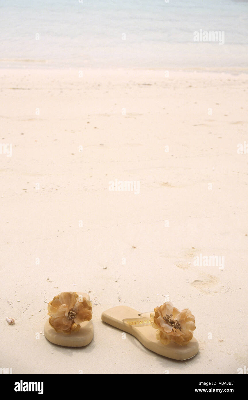 Gold flip flops on beach Baros island resort Maldives Stock Photo - Alamy