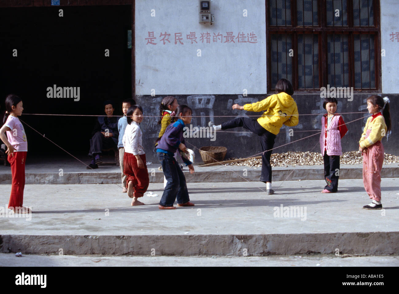 Children playing physical game with strings exercise small rural ...