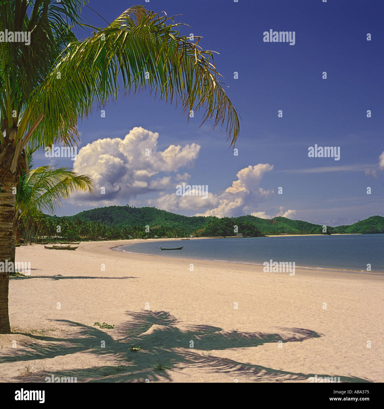 View along the semi circular Pelangi Beach with palm tree in left ...