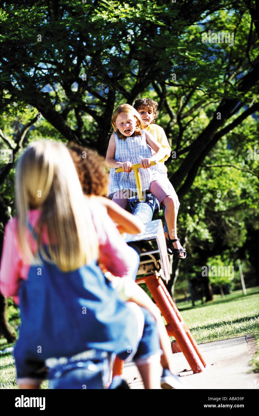 Children playing on a seesaw Stock Photo - Alamy