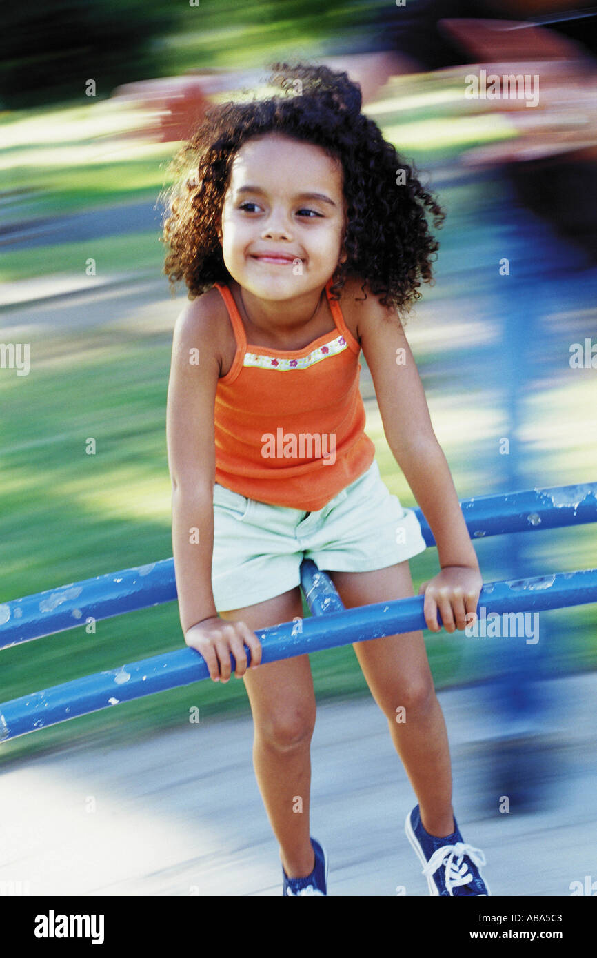 Girl on a roundabout Stock Photo - Alamy