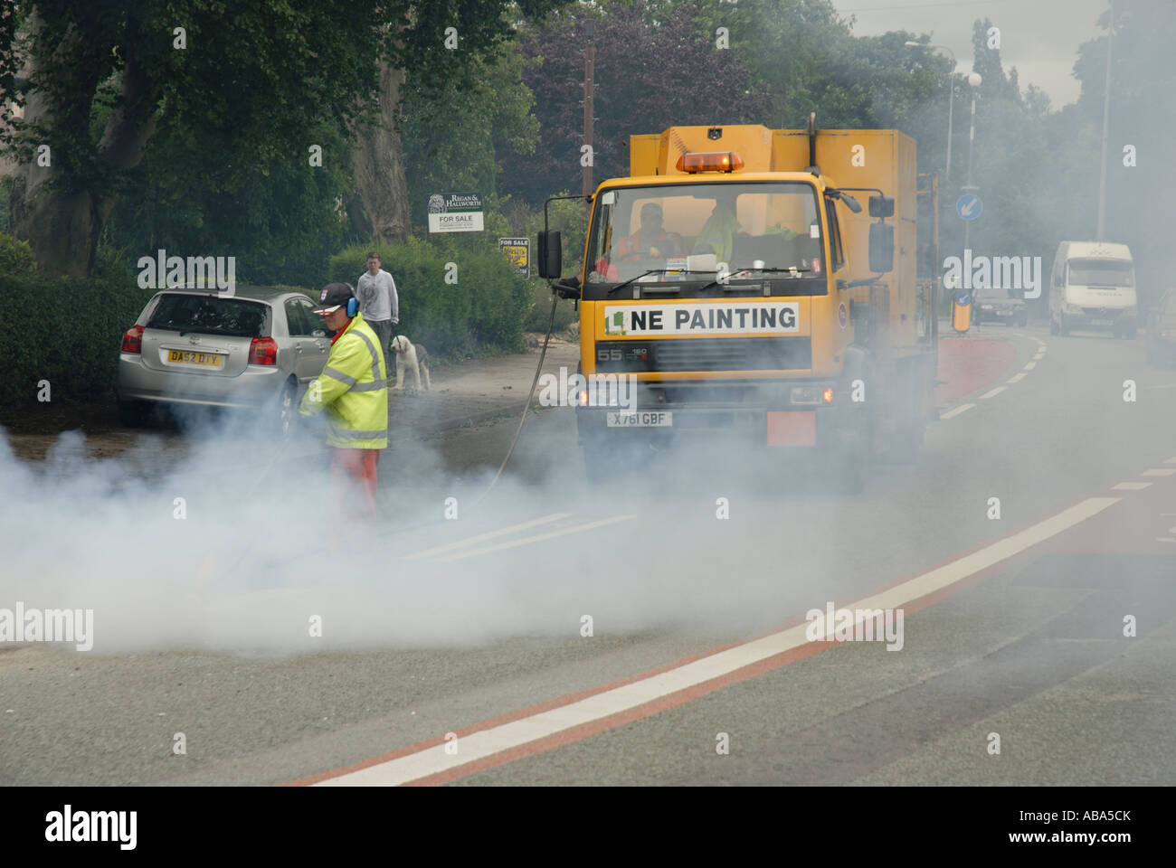 Burning off old white lines in preparation for re-marking the road ...