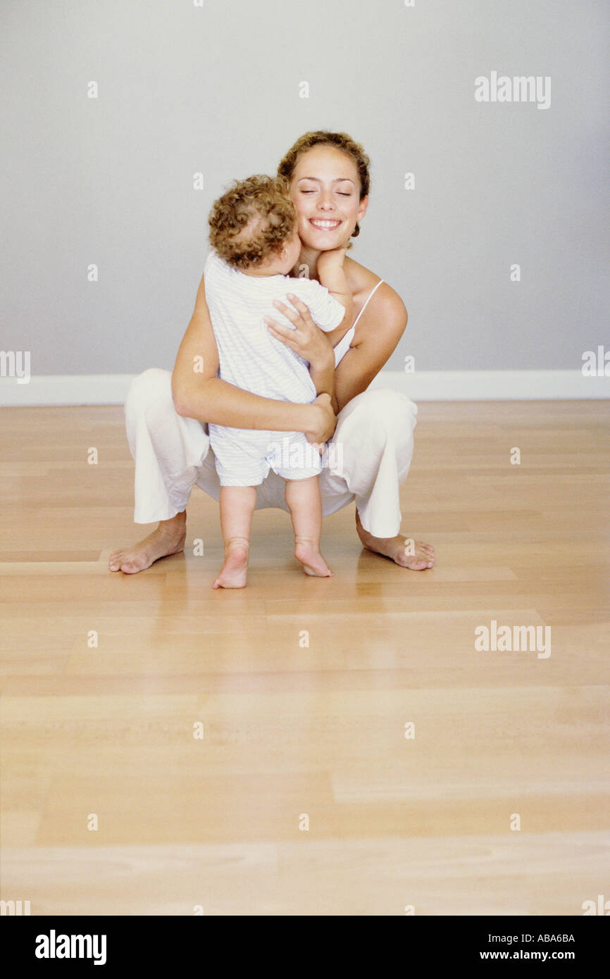 Mother hugging baby Stock Photo - Alamy