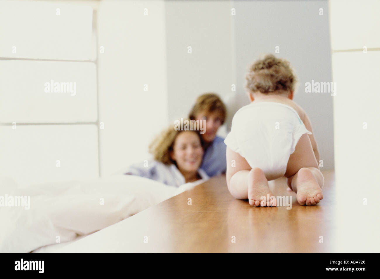 Baby crawling on counter Stock Photo - Alamy