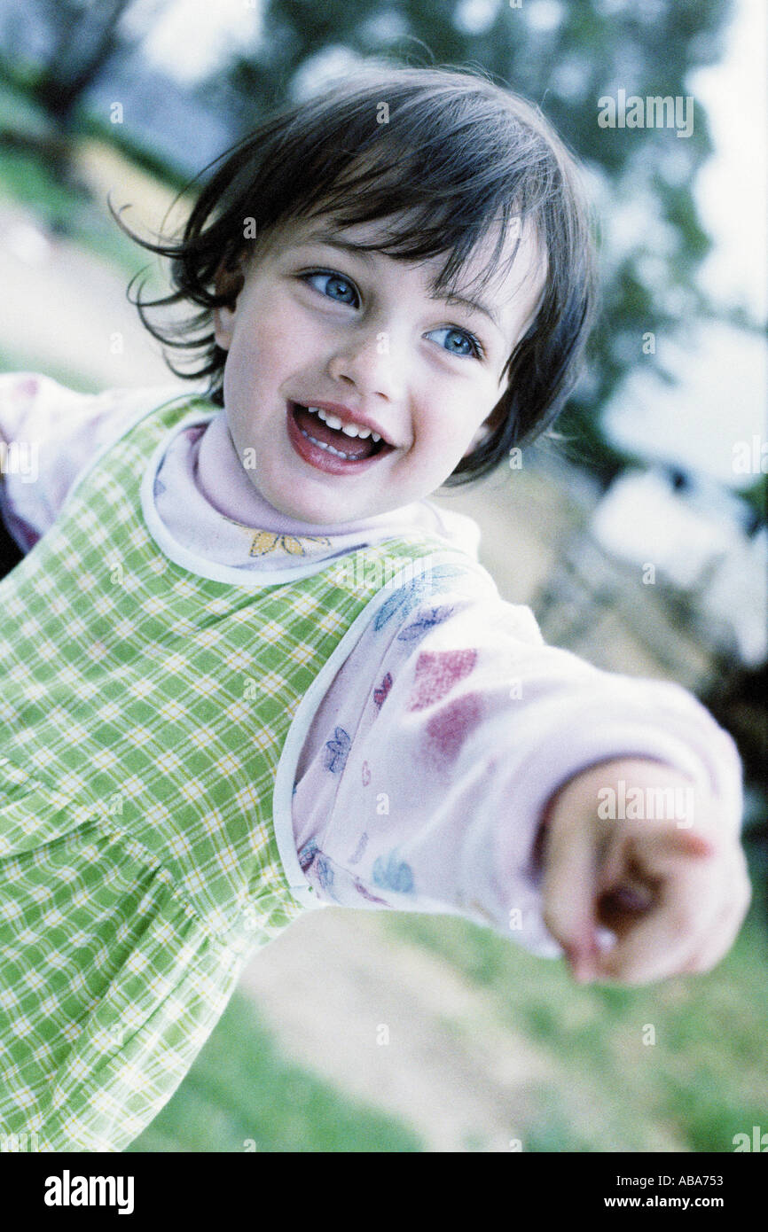 Smiling girl pointing Stock Photo - Alamy