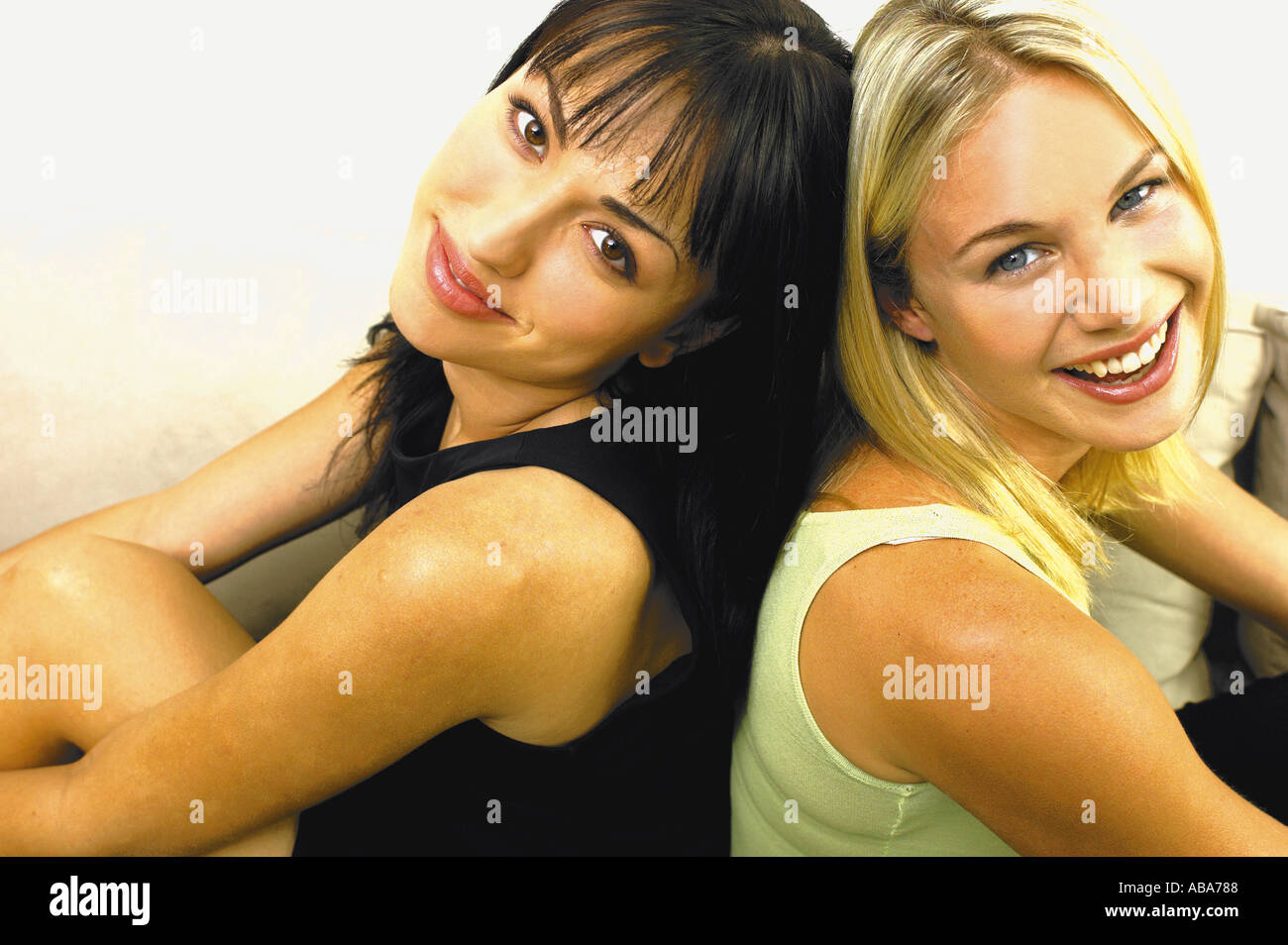 Two women back to back Stock Photo - Alamy