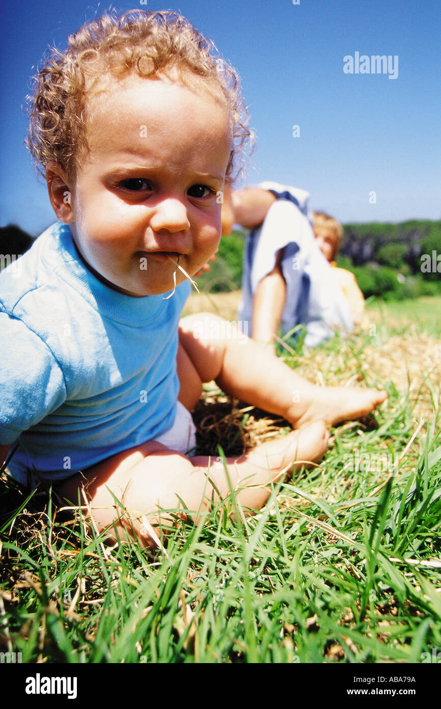 Toddler eating grass Stock Photo - Alamy