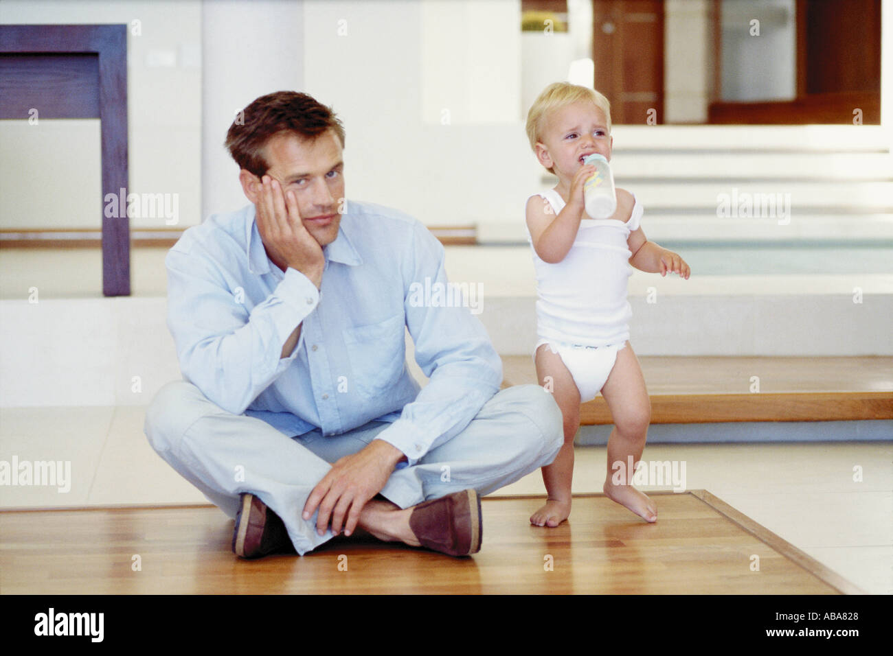 Tired father with crying toddler Stock Photo - Alamy