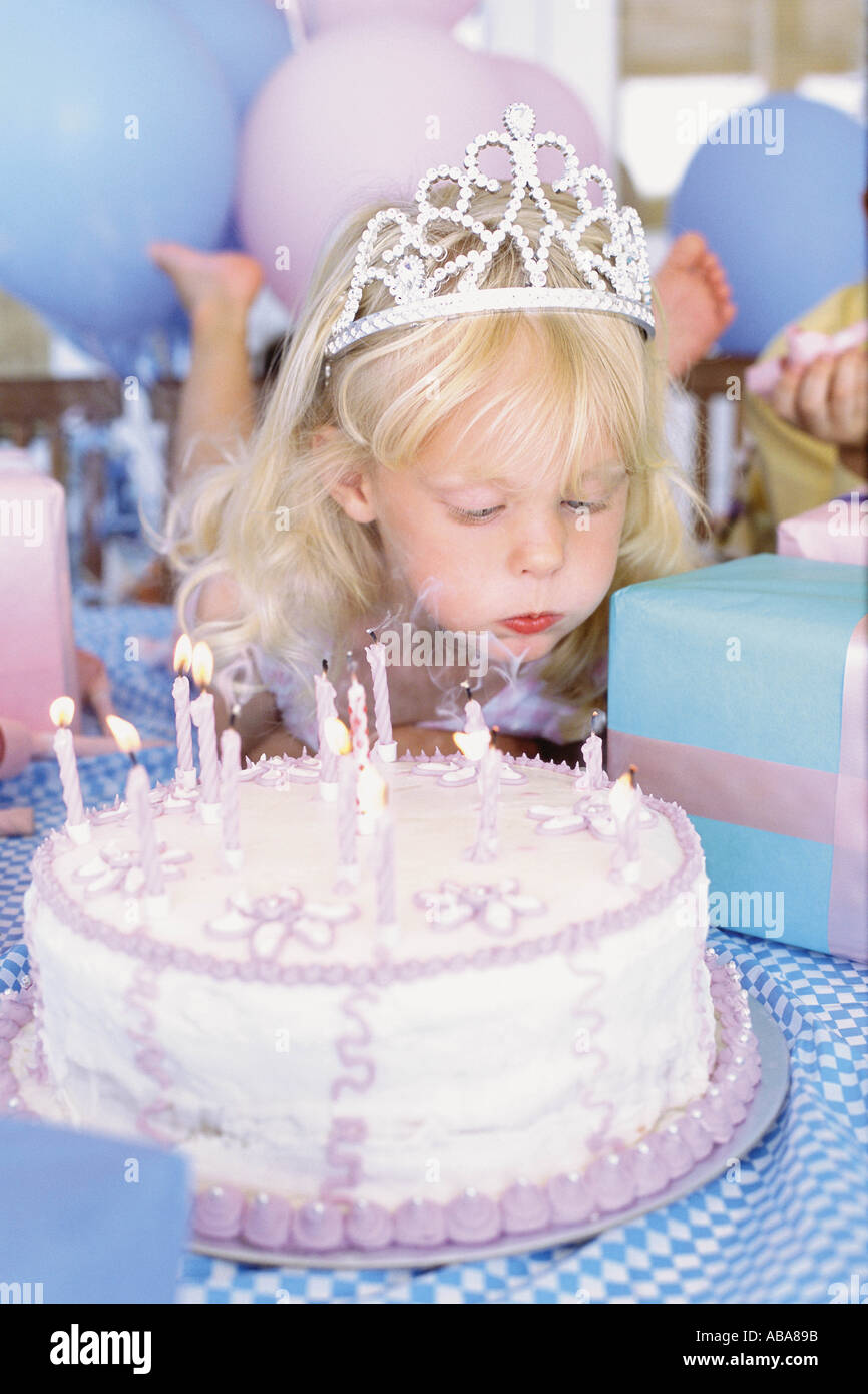 Portrait of a birthday girl blowing the candles Stock Photo - Alamy