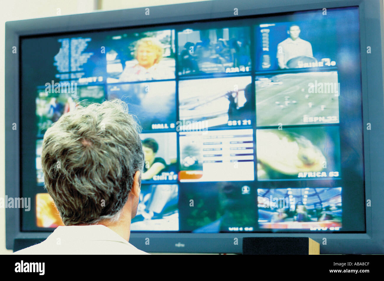 Man looking at television Stock Photo - Alamy