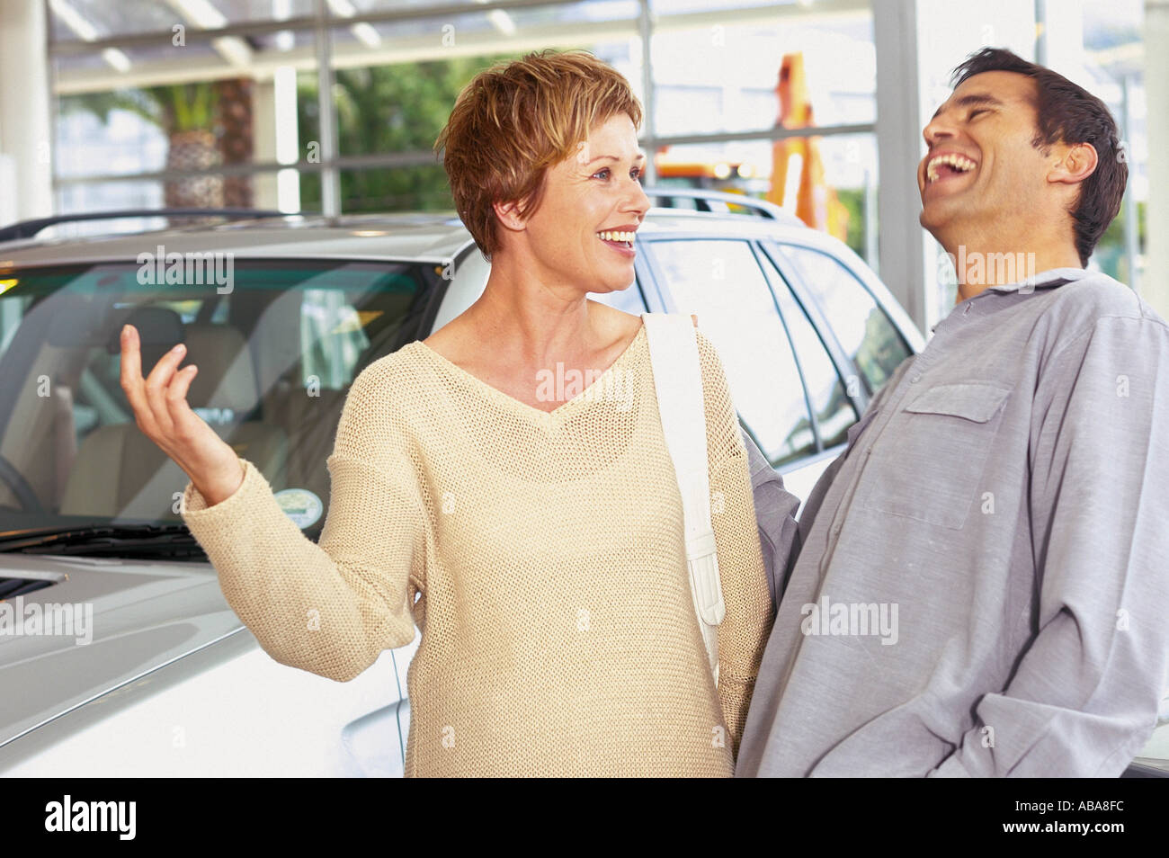 Couple in a car dealership Stock Photo - Alamy