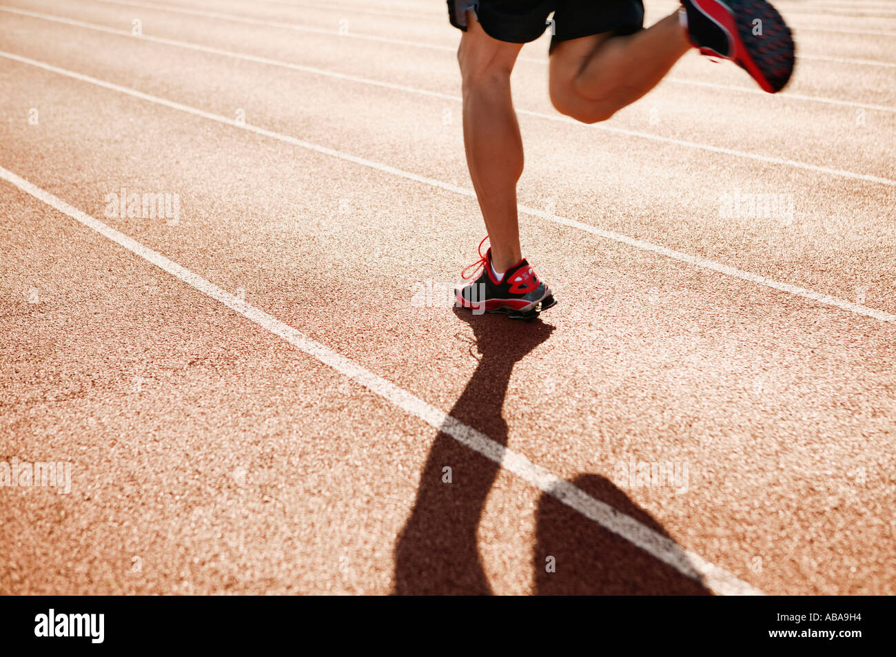 Male athlete running on a track Stock Photo - Alamy