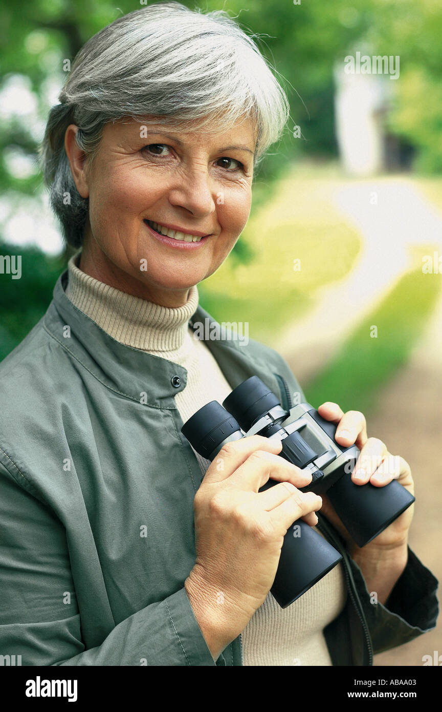 Woman with binoculars hi-res stock photography and images - Alamy
