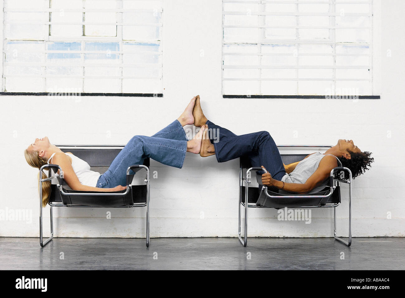 Couple playing on chairs Stock Photo - Alamy