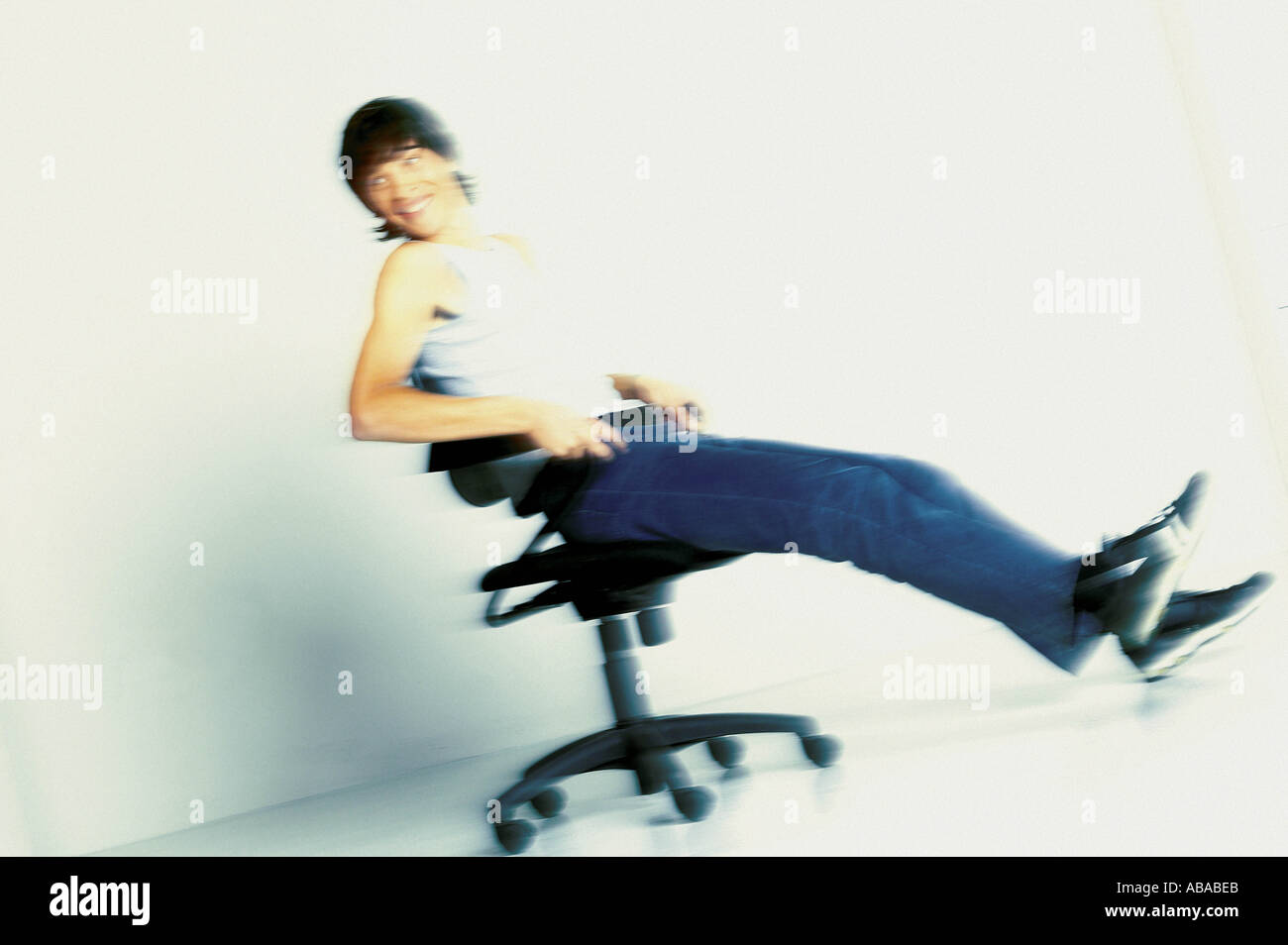 Man leaning back on office chair Stock Photo - Alamy