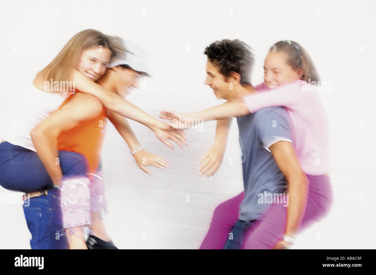 Teenage boys and girls playing piggyback Stock Photo - Alamy