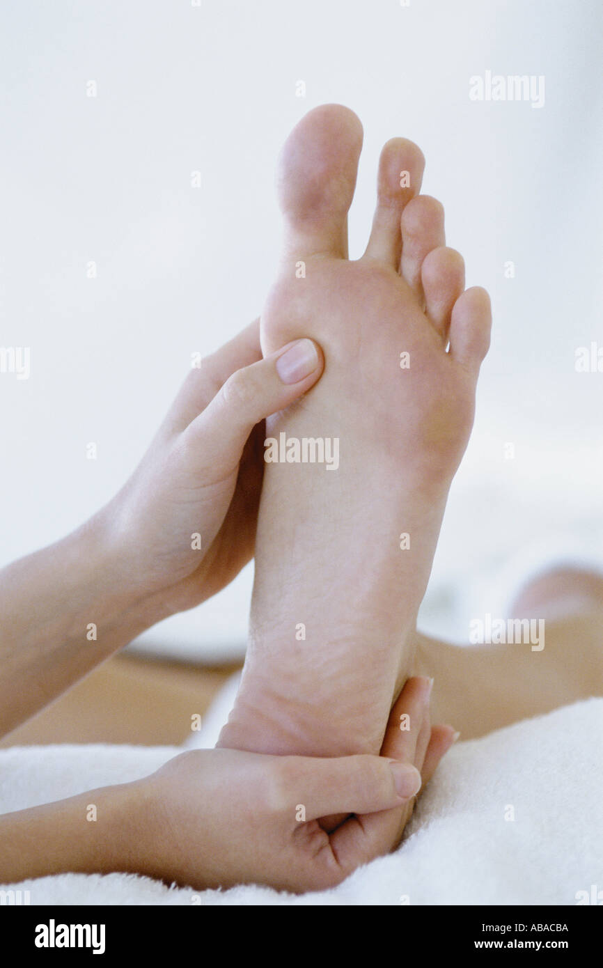 Woman receiving reflexology treatment Stock Photo - Alamy
