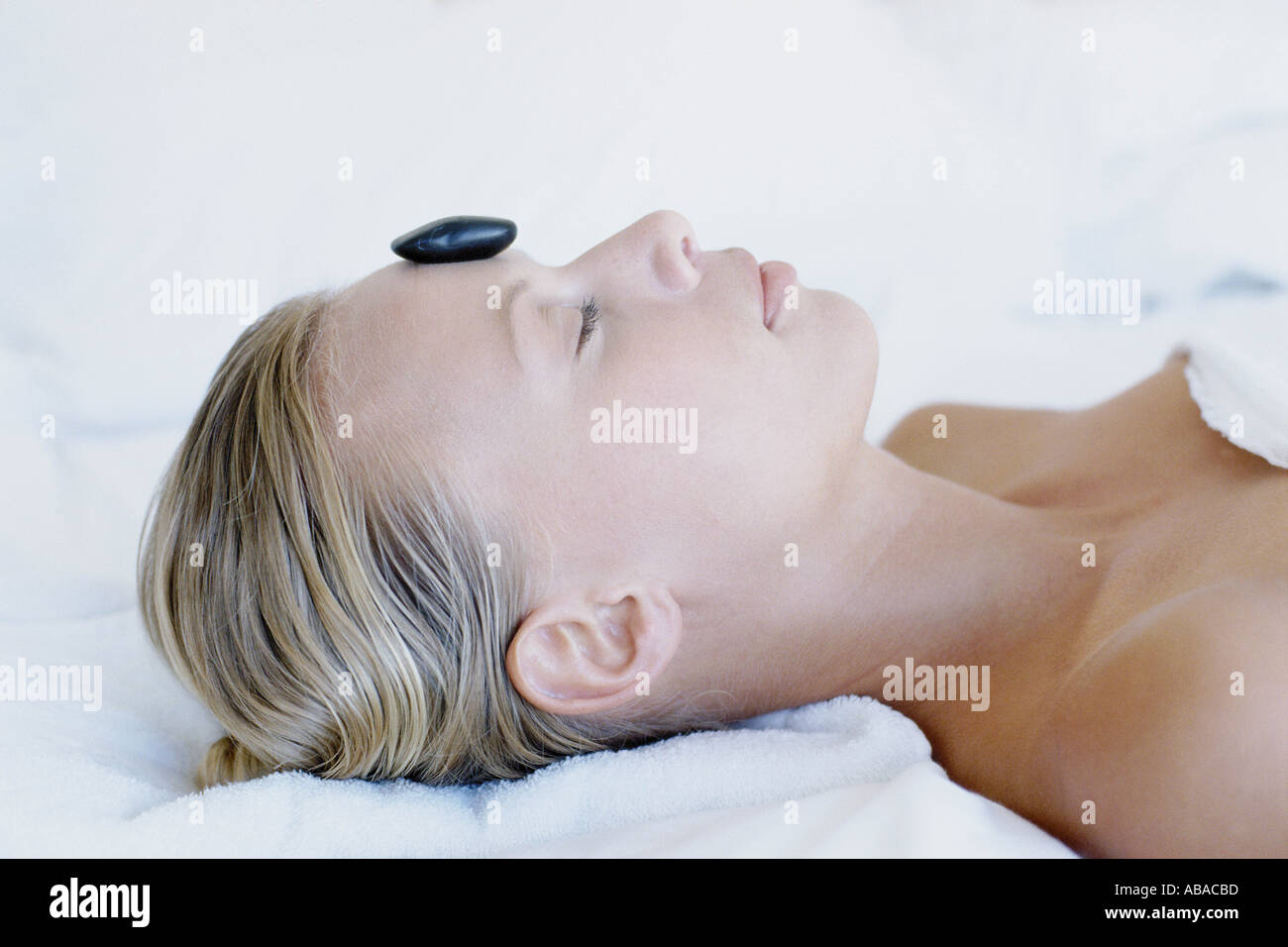 Woman receiving hot rock treatment Stock Photo - Alamy