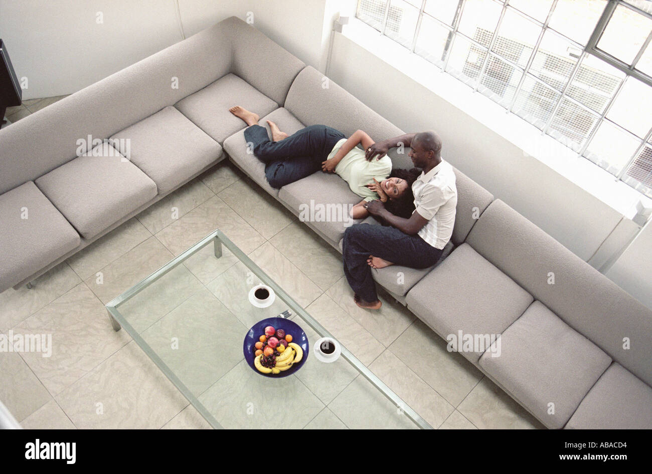 Couple on couch Stock Photo - Alamy