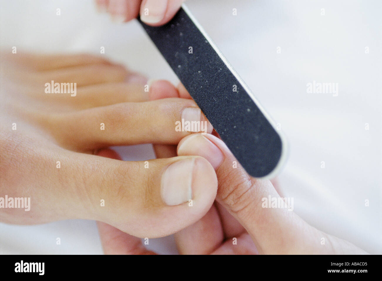 Woman filing foot file hi-res stock photography and images - Alamy