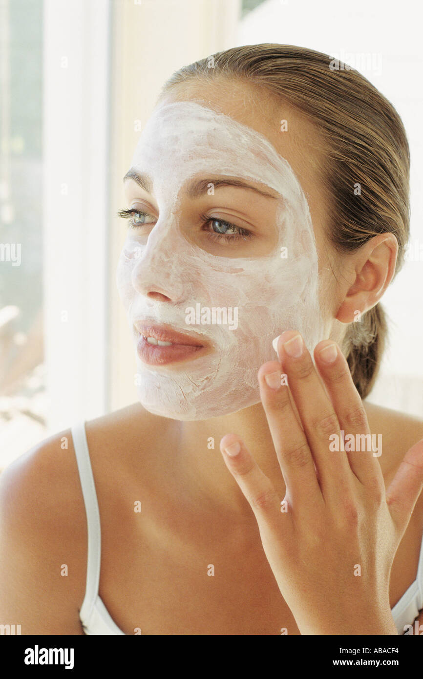 Woman applying face mask Stock Photo - Alamy Woman applying face mask Stock Photo - Alamy