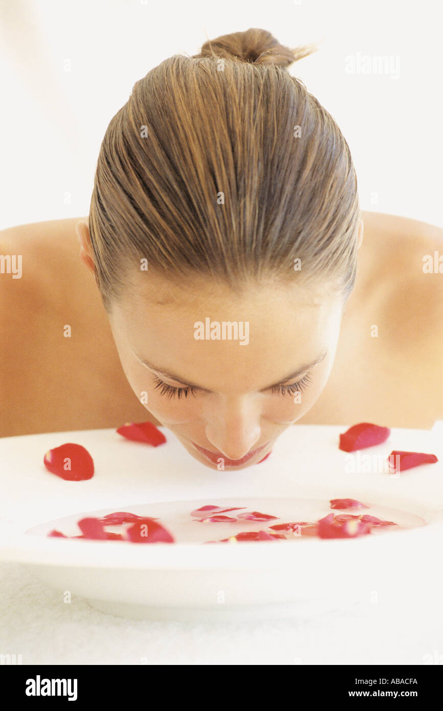 Woman rinsing face Stock Photo - Alamy