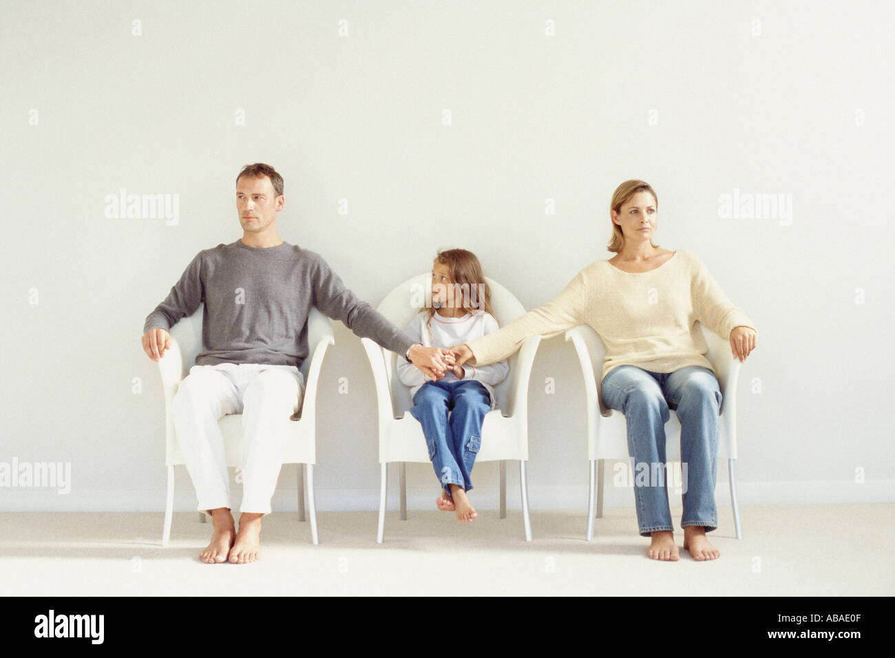 Family sitting in a row Stock Photo - Alamy
