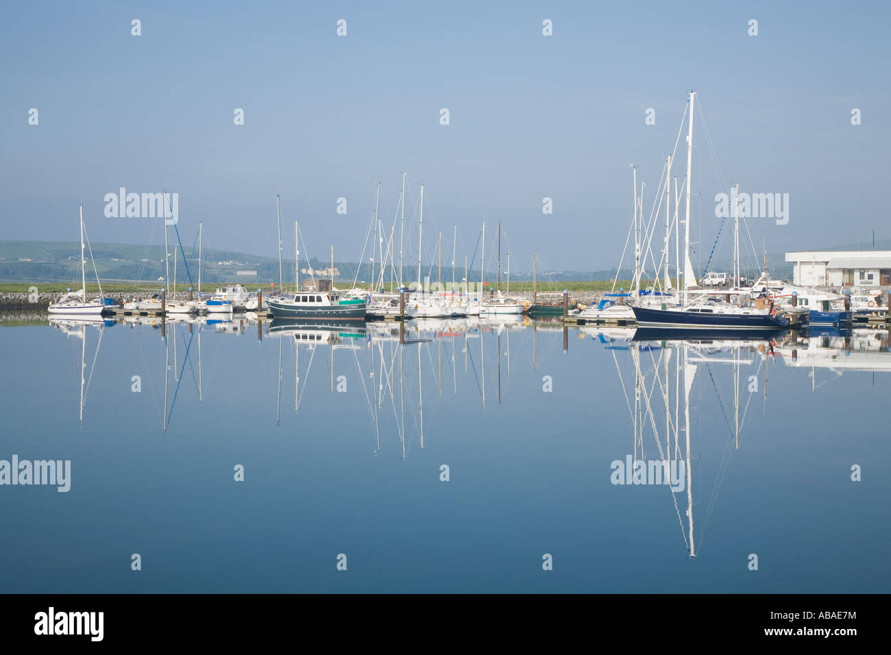 Sailing and motor boats in Dingle harbour with a blue sky and ...
