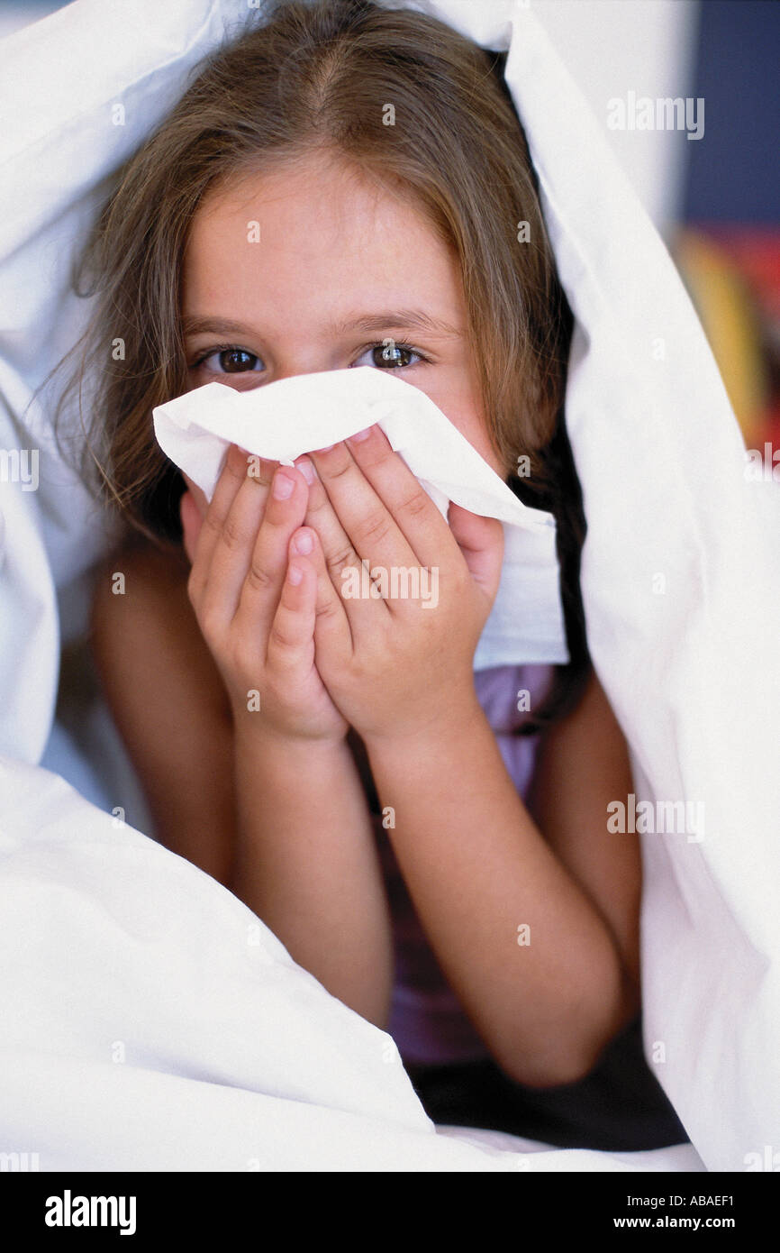 Girl blowing nose Stock Photo - Alamy