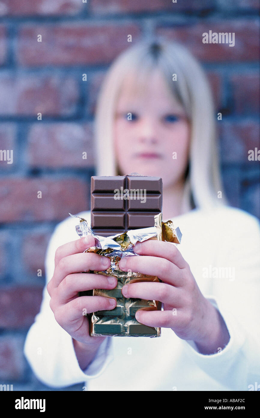 Girl offering chocolate Stock Photo - Alamy