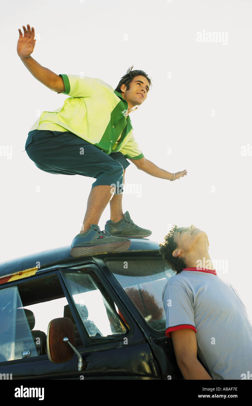 Man standing on van Stock Photo - Alamy