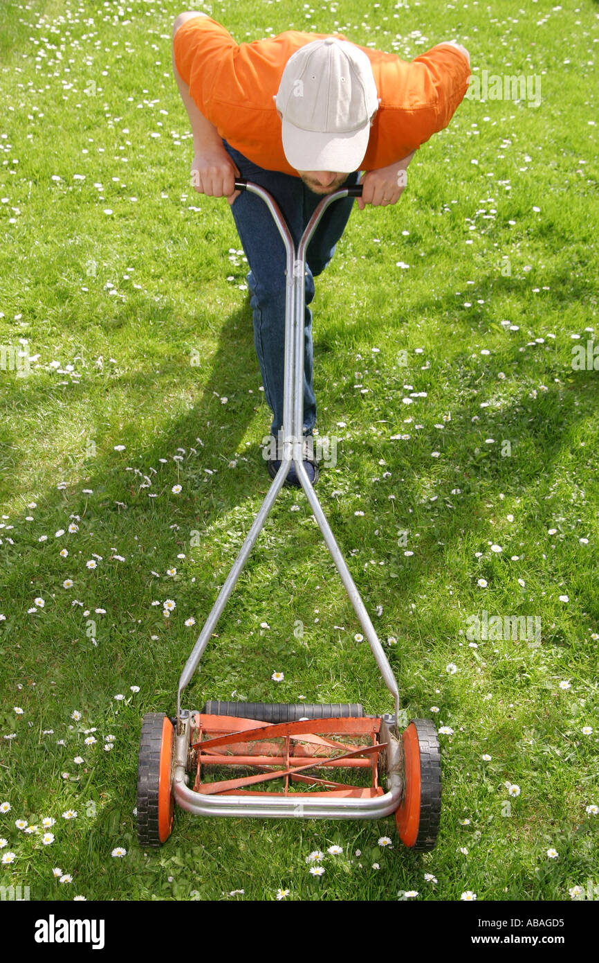 36 year old man mowing the lawn Stock Photo - Alamy