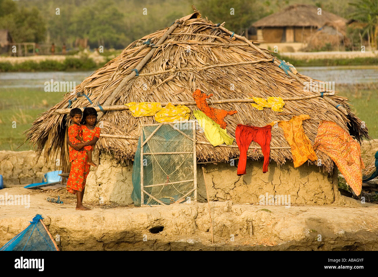 Poor fishing village and thached roof mud houses along Passur River ...