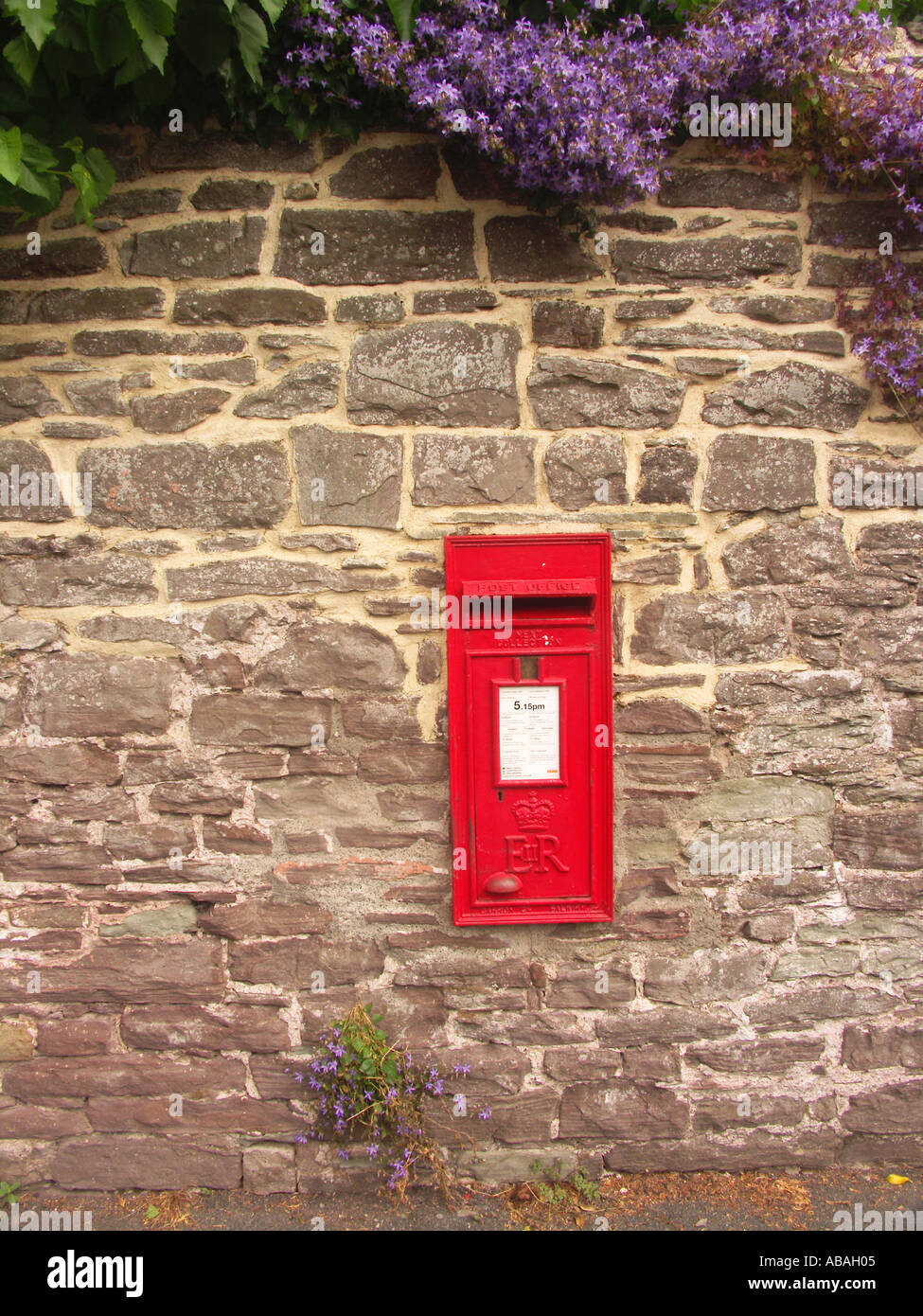 Red post box in stone wall Stock Photo - Alamy