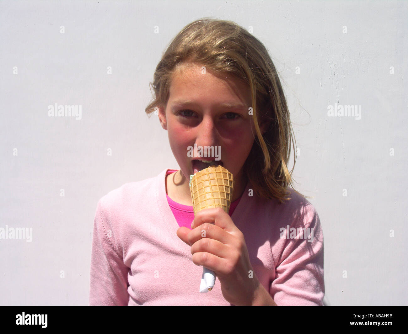 Girl eating ice cream cone Stock Photo - Alamy