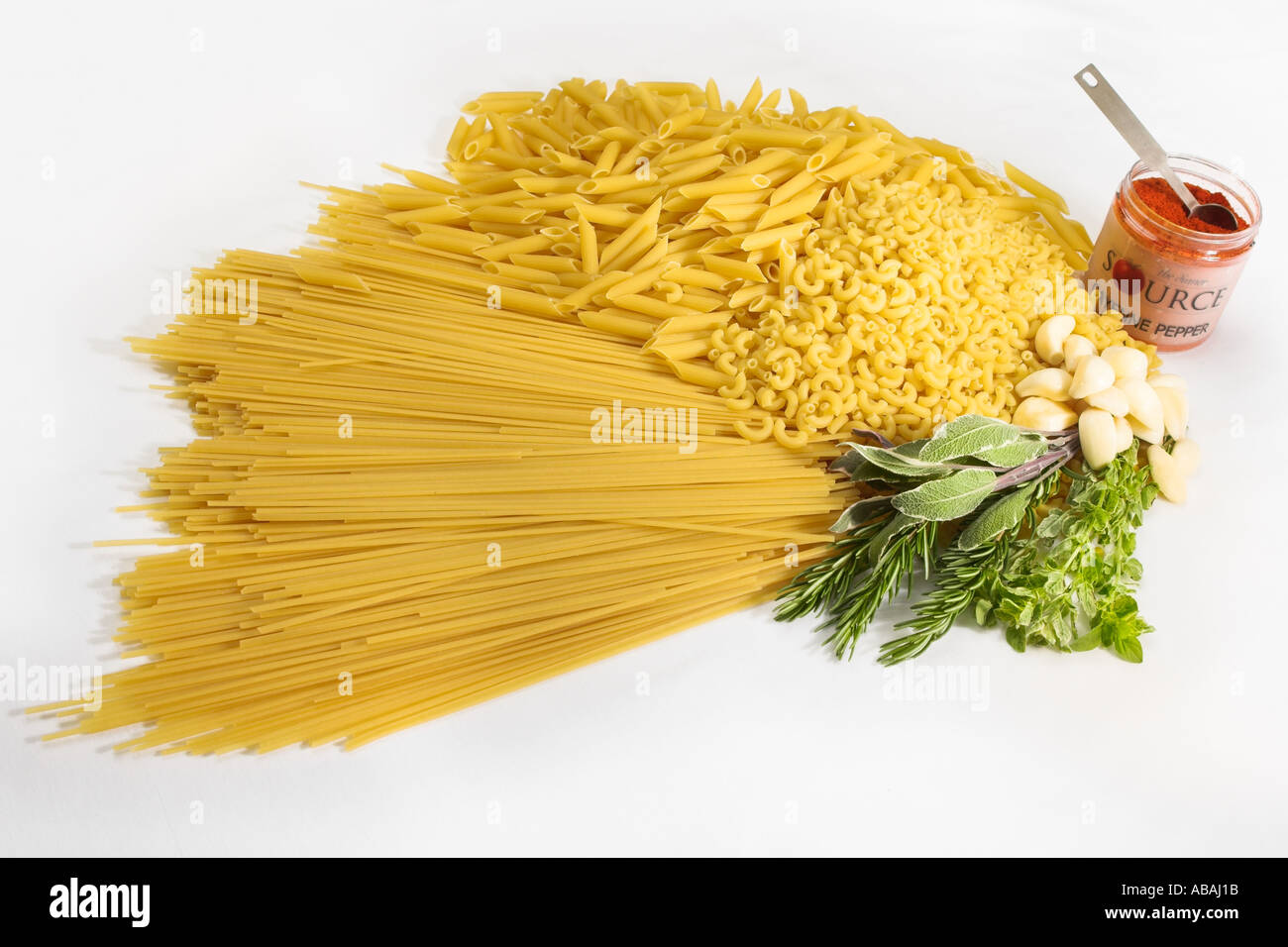 White background full of uncooked raw pasta herbs spices spaghetti ...