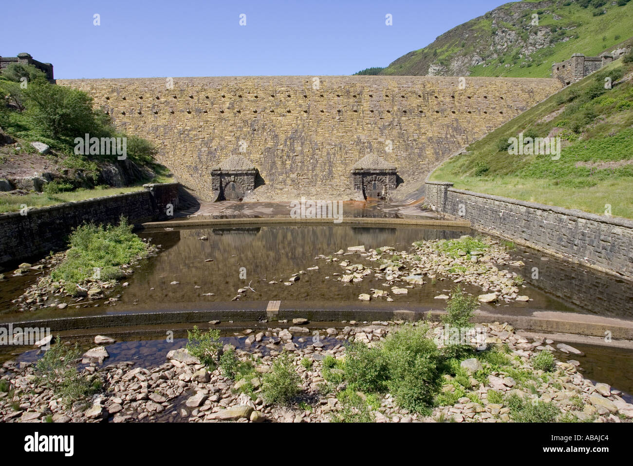 Dam wall built in the 1890s at Caban Coch reservoir with electricity ...